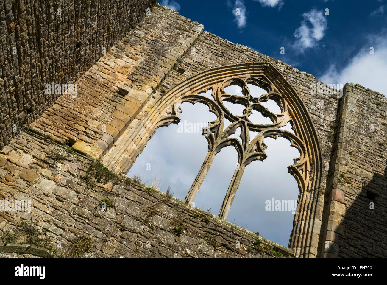 Stone facade and decorative window of a ruined building; North ...