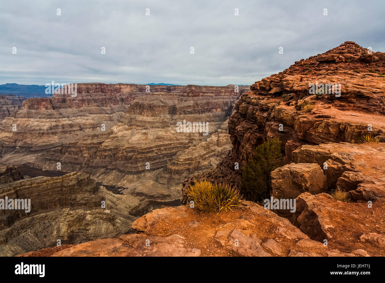 Rugged landscape with rock showing layers of sediment and erosion ...
