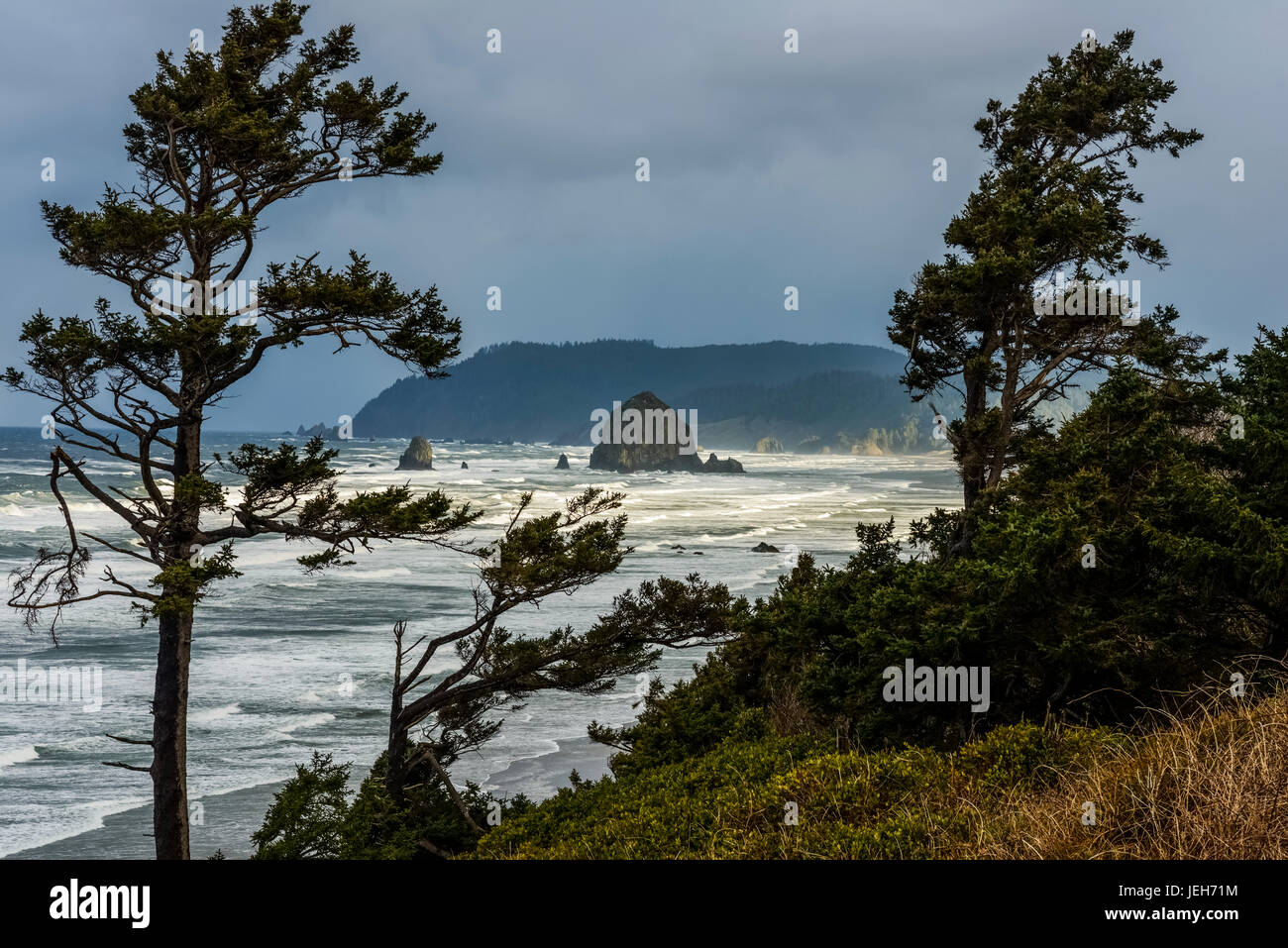 Sunlight breaks through the storm on the Oregon Coast; Cannon Beach ...