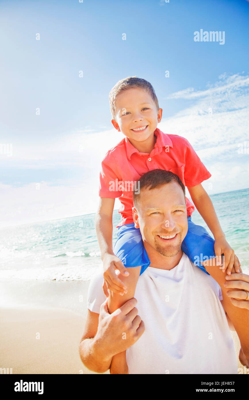 A father and son spending time on a tropical beach on vacation ...