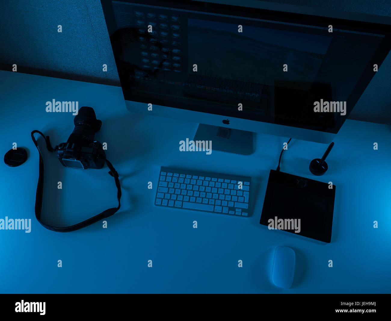 Blue cast technology desk overhead setup Stock Photo - Alamy