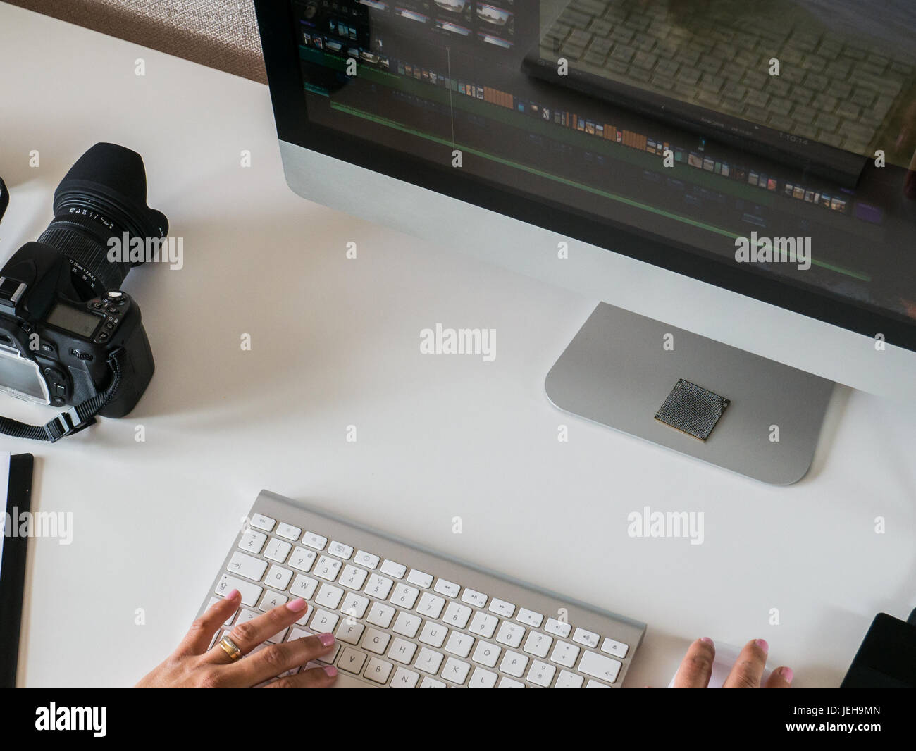 Woman working a video editing project on a modern computer setup Stock ...