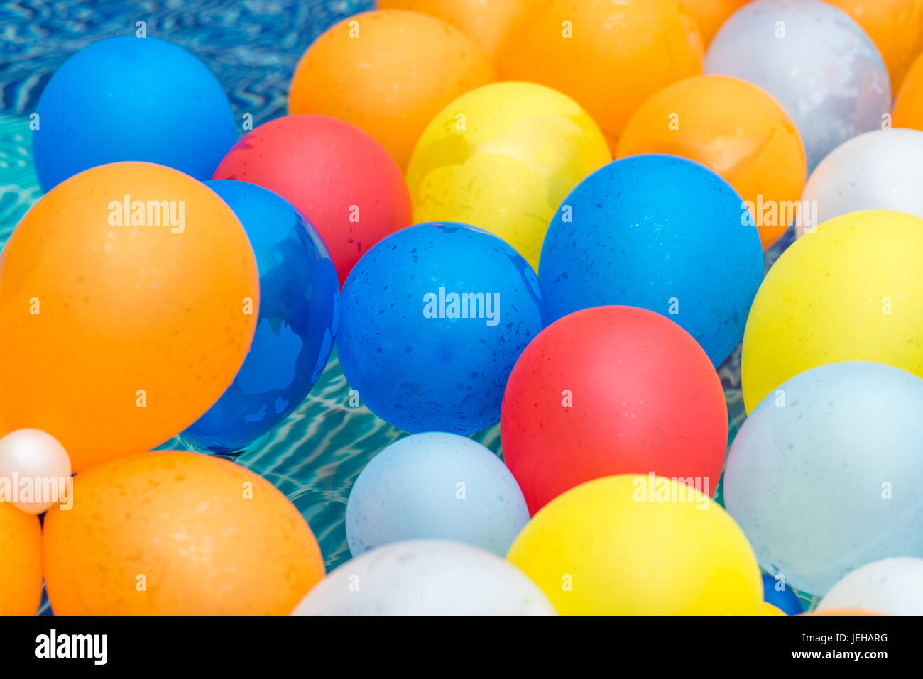 color balloons floating in a pool Stock Photo - Alamy