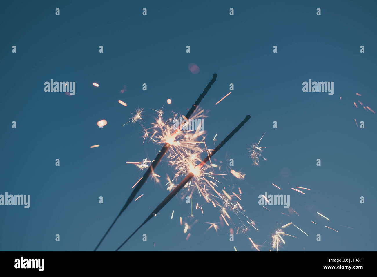 Burning Sparklers and Blue Sky Stock Photo - Alamy