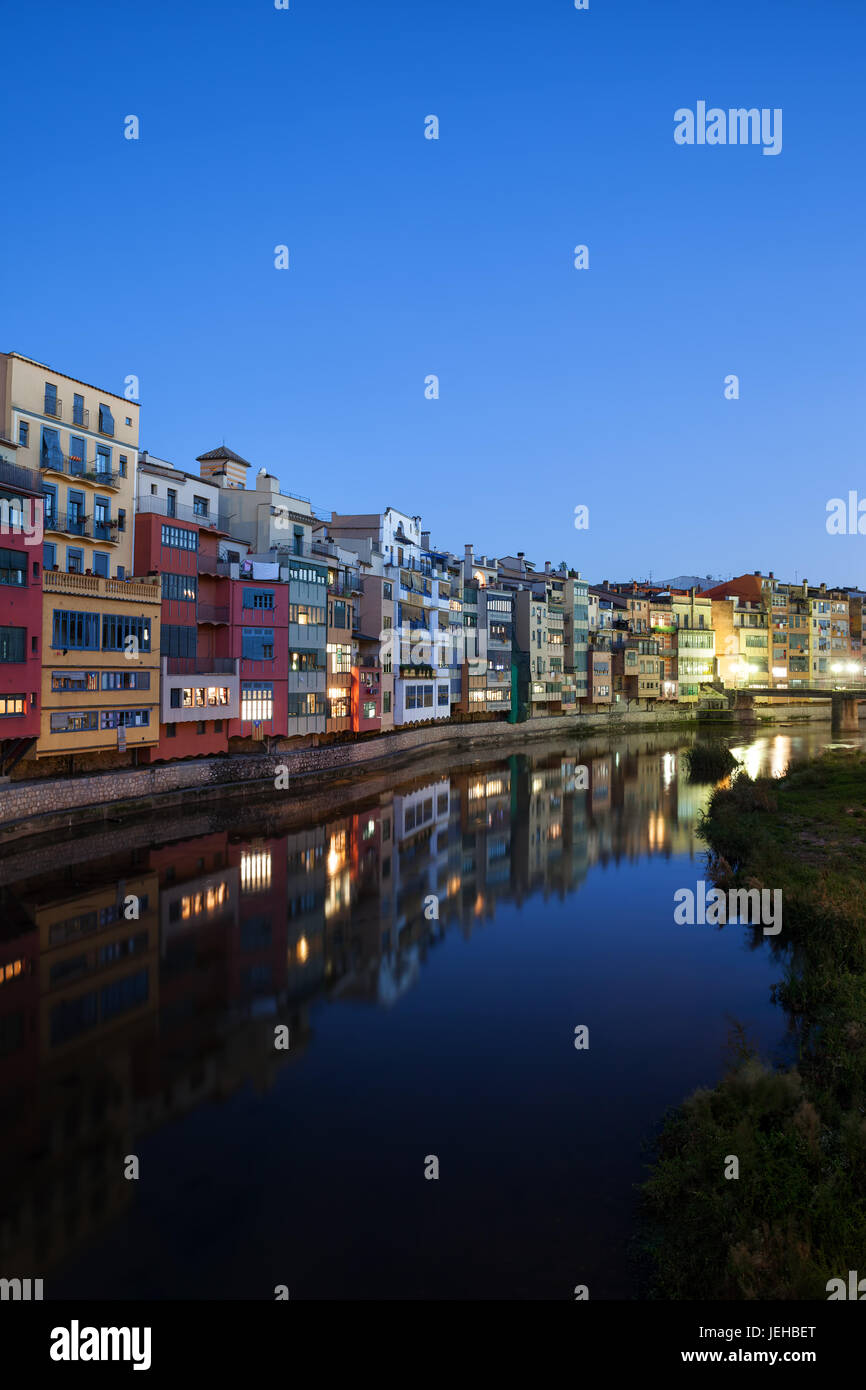 Girona city skyline and cityscape at dusk, Old Town riverside houses on ...