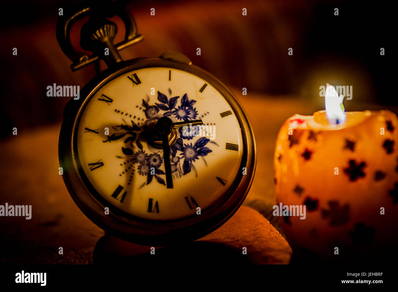 old bronze watch beside candle Stock Photo - Alamy