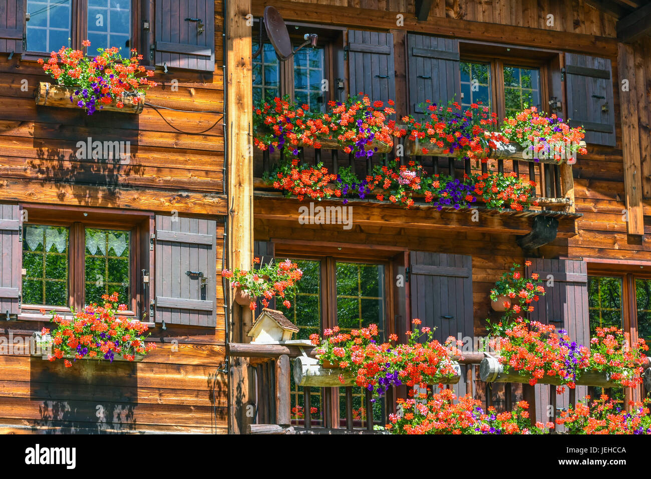 Swiss style wooden house with geraniums, Chamonix Mont Blanc, France ...