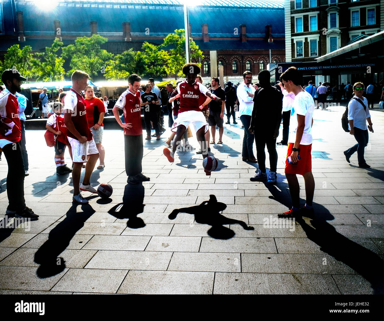 kids juggling football in street Stock Photo - Alamy