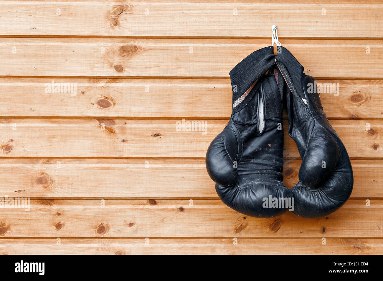 Pair of boxing gloves hanging in a rustic wooden wall Stock Photo - Alamy