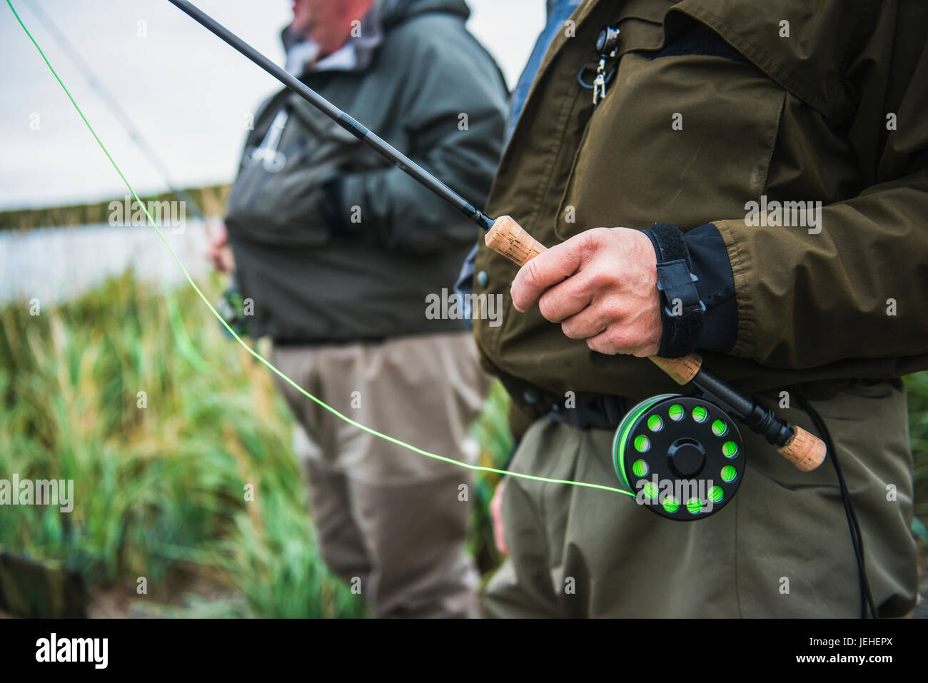 Two fly fishermen standing along the Ugashik River, Southwest Alaska ...