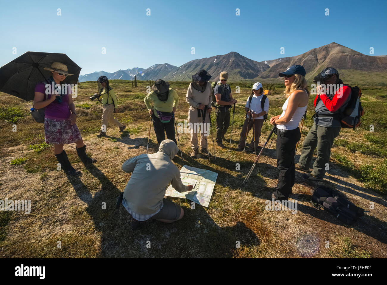 A group of hikers prepare for a day hike in the backcountry near Twin ...