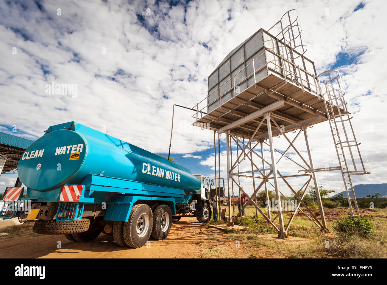 A clean water truck sits below a water storage tank; Kenya Stock Photo ...
