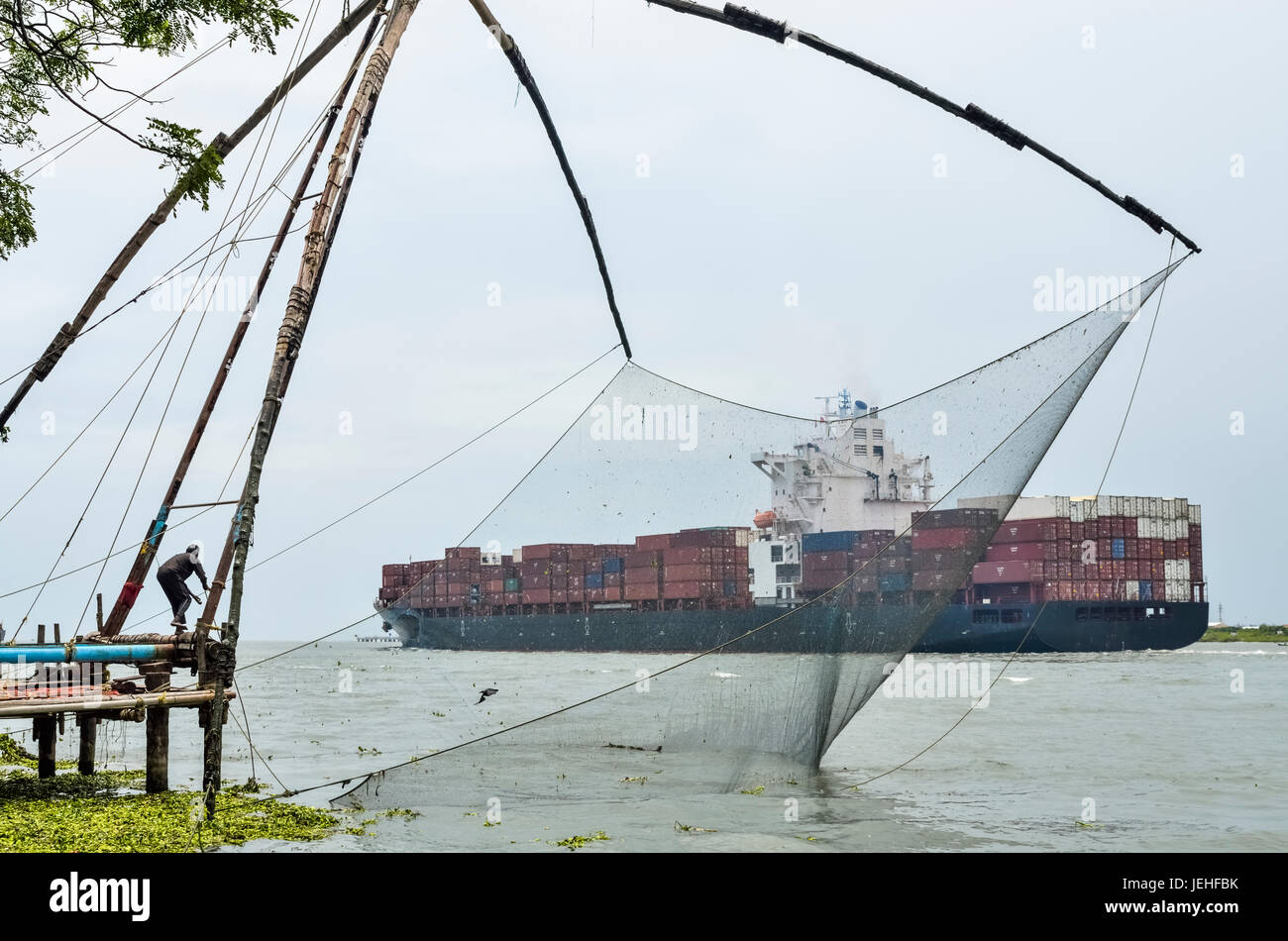 Chinese fishing nets with container ship in background; Kochi ...