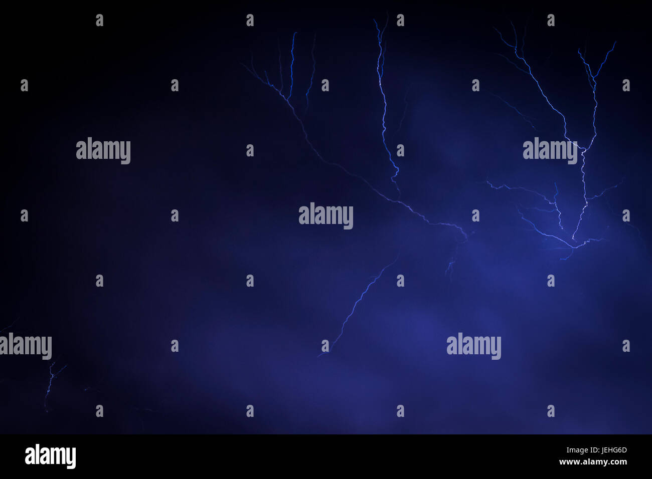 Lightning at night on a dark blue sky Stock Photo - Alamy