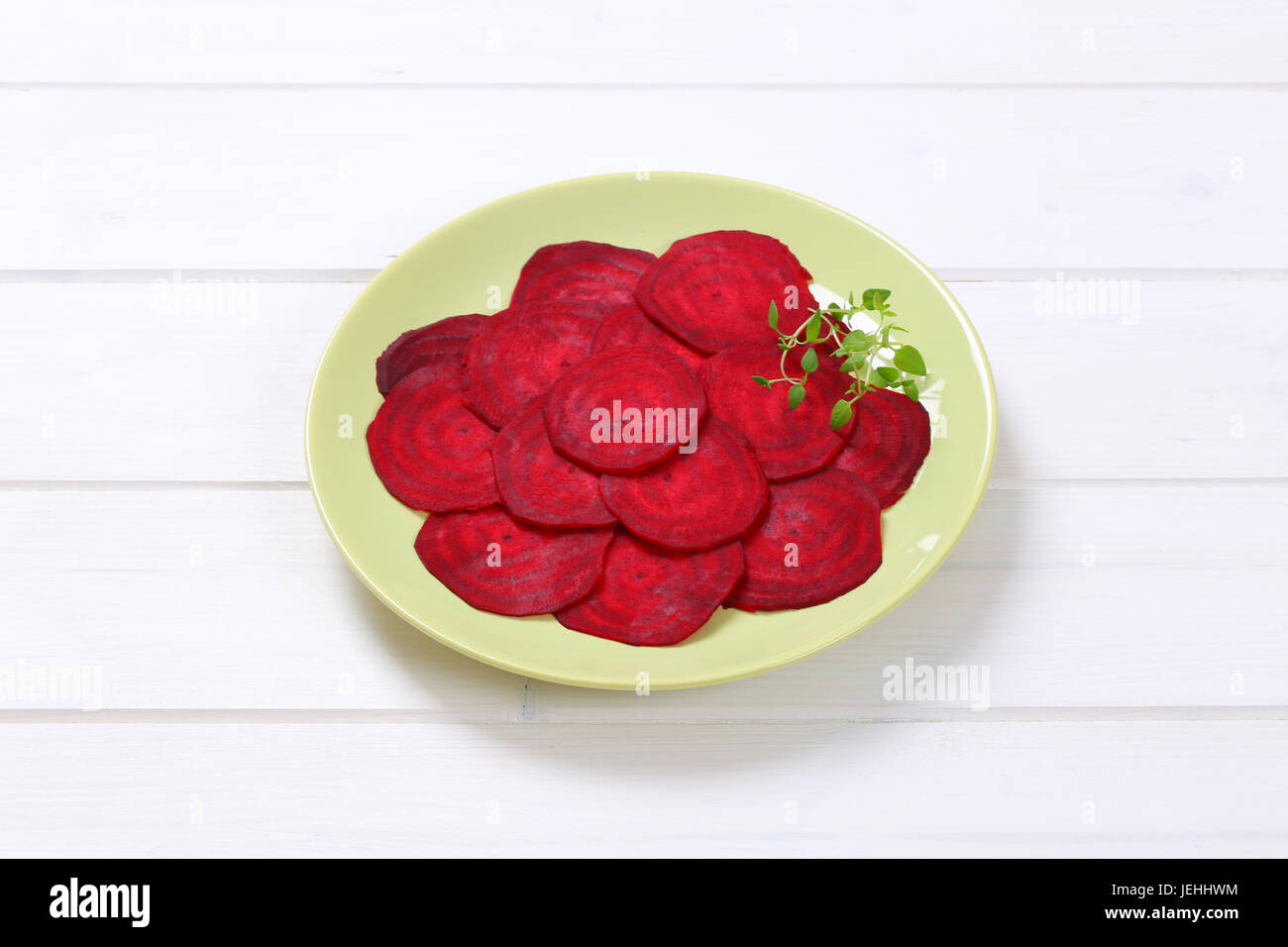 plate of thin beetroot slices on white wooden background Stock Photo ...