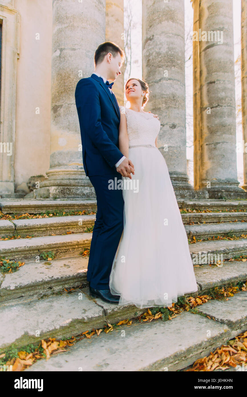 Couple holding hands near wedding hi-res stock photography and images ...