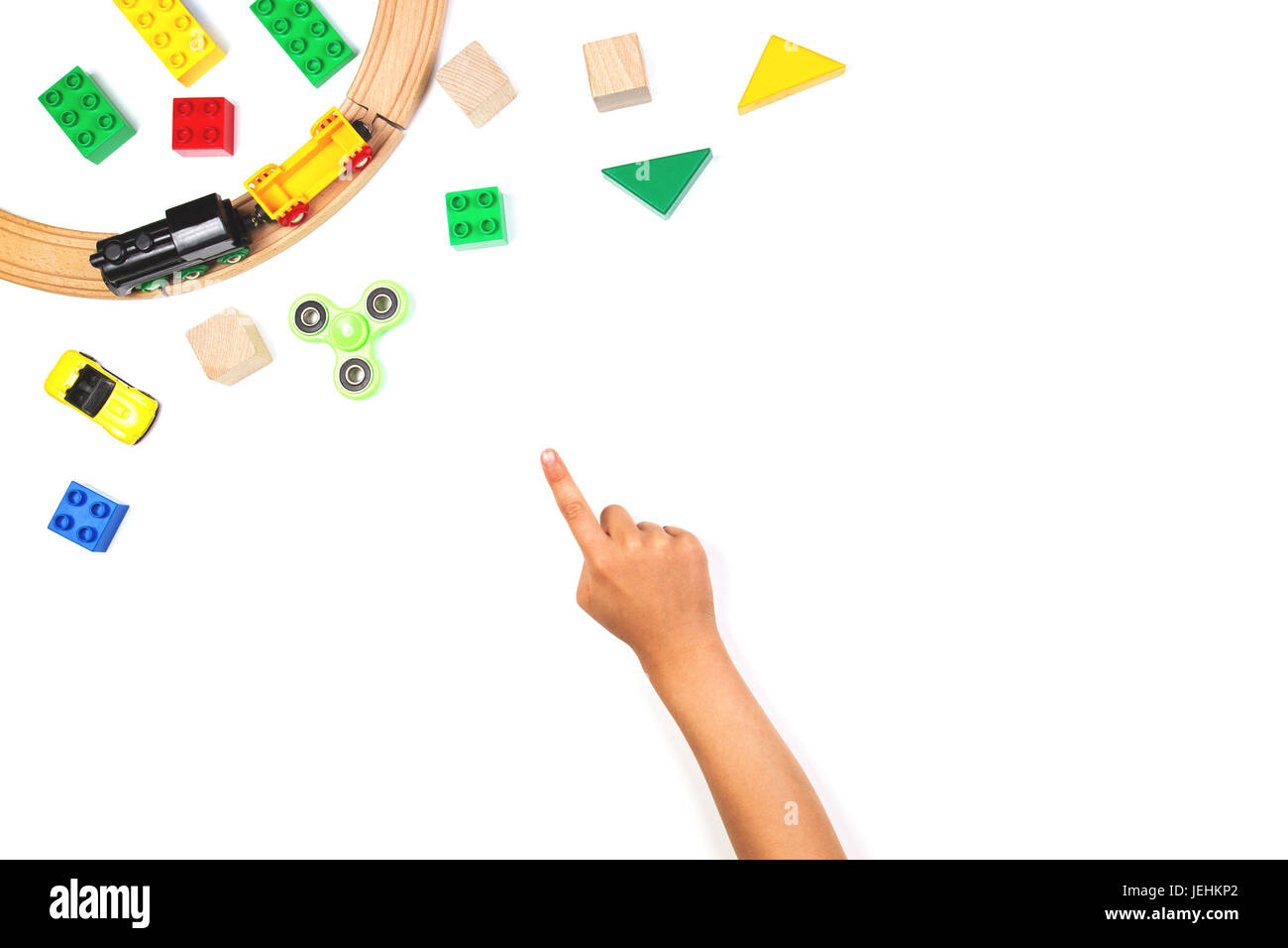 Kid pointing finger to colorful toys. Fidget spinner, cars, toy train ...