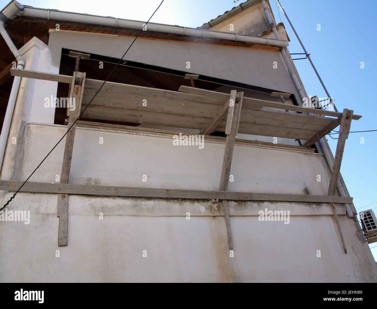 Makeshift wooden structure acting as access platform to carry out DIY ...