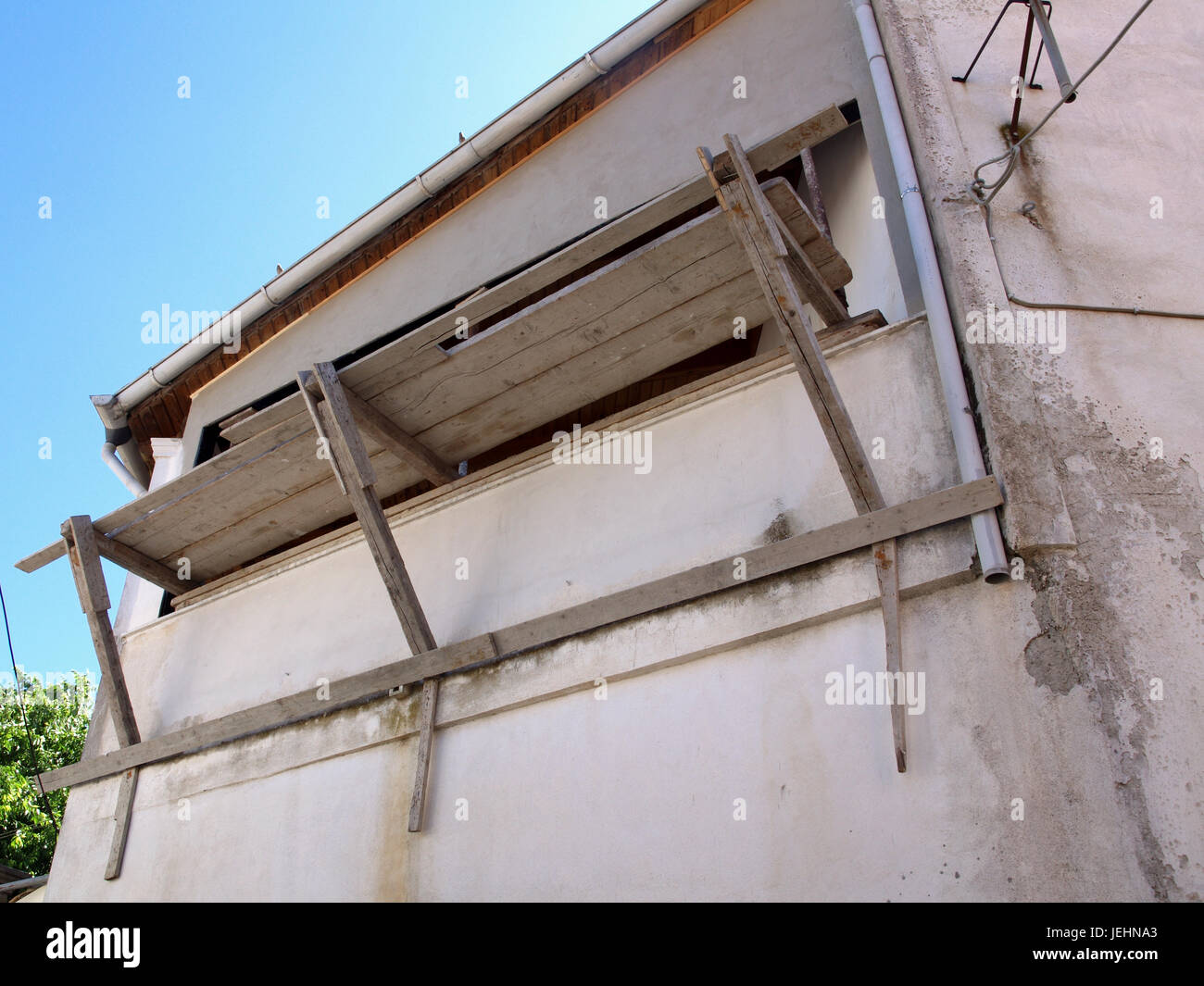 Makeshift wooden structure acting as access platform to carry out DIY ...