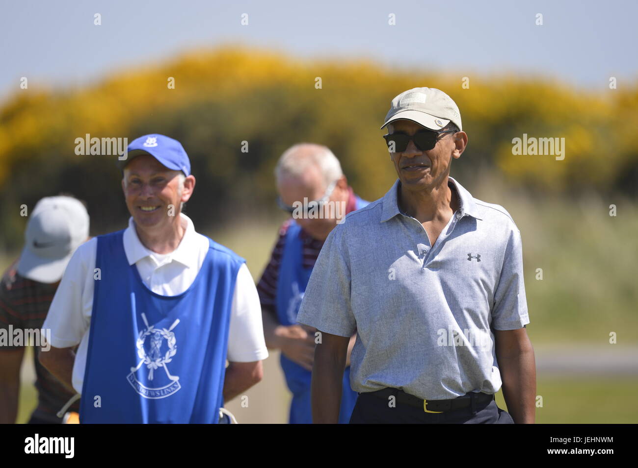 Former US president Barack Obama (light blue shirt) playing a round of ...