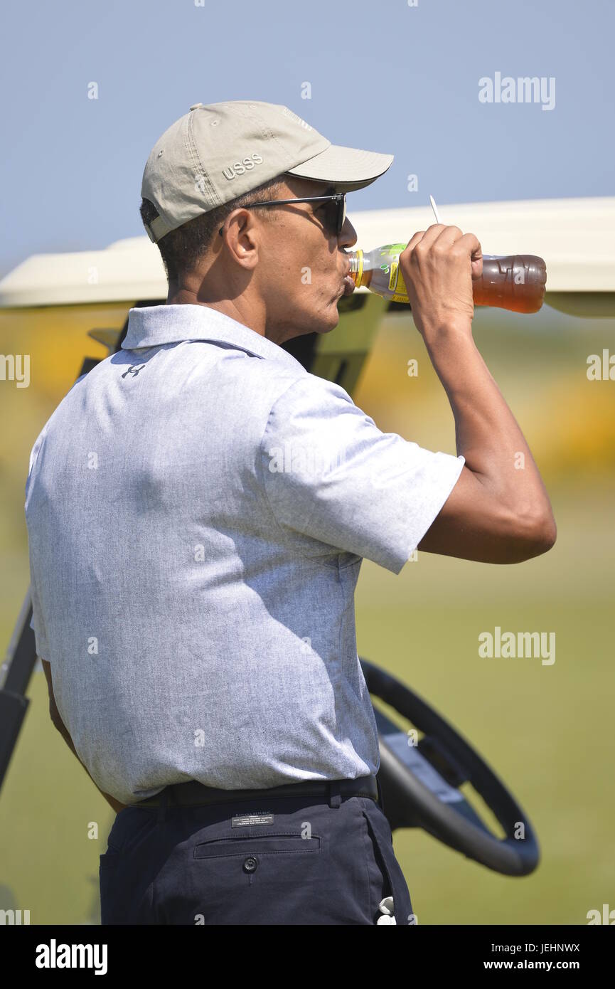 Former US president Barack Obama (light blue shirt) playing a round of ...