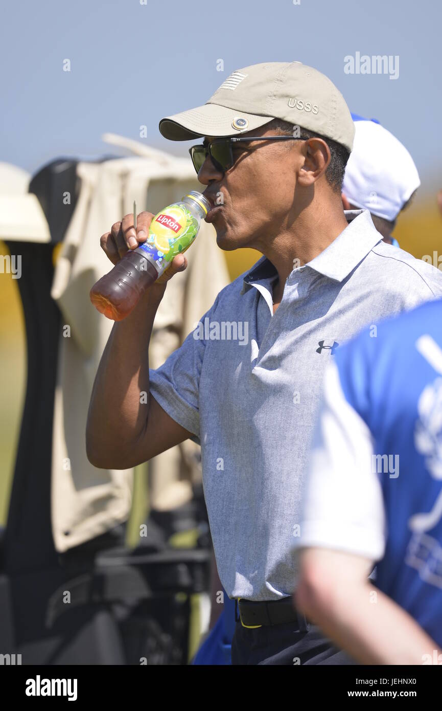 Former US president Barack Obama (light blue shirt) playing a round of ...