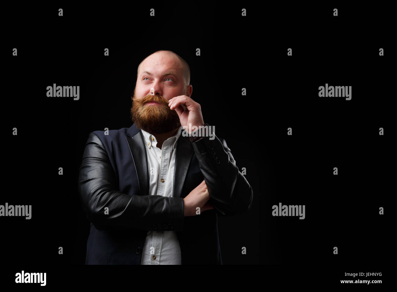 Pensive man twirling his mustache Stock Photo - Alamy