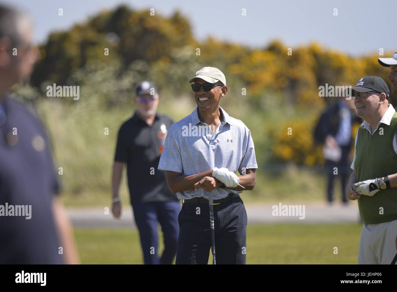 Former US president Barack Obama (light blue shirt) playing a round of ...