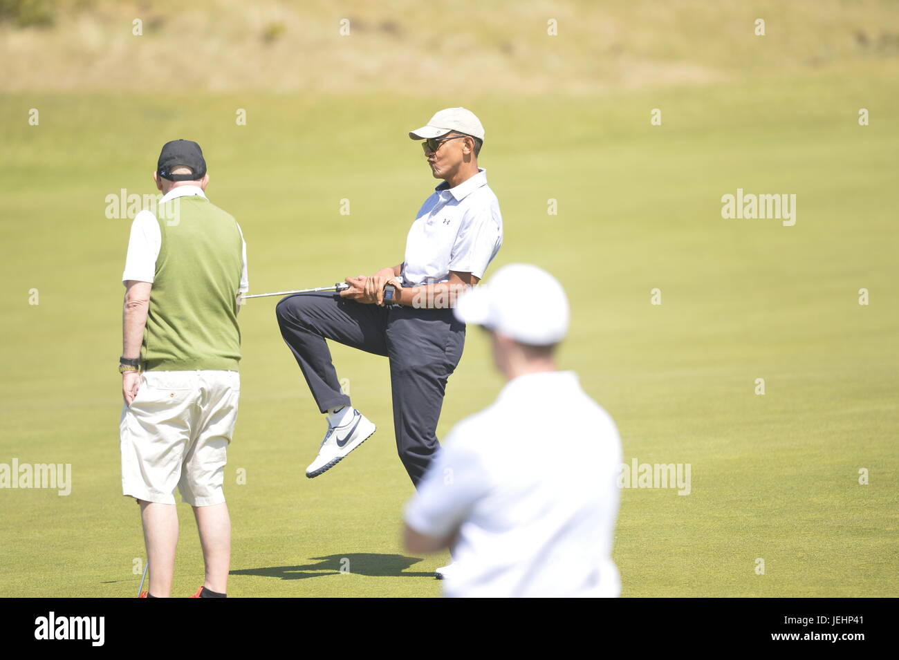 Former US president Barack Obama (light blue shirt) playing a round of ...