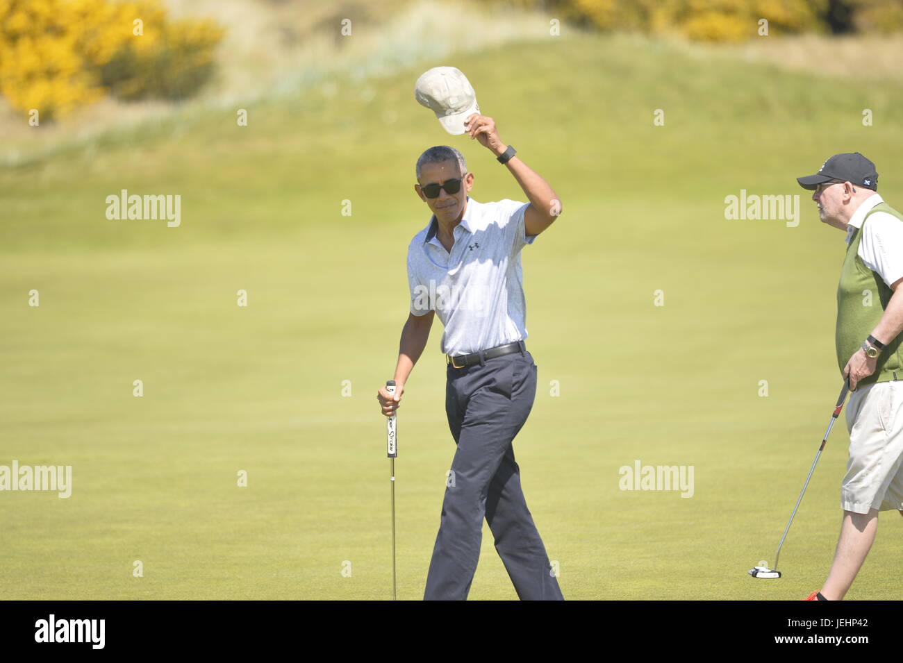 Former US president Barack Obama (light blue shirt) playing a round of ...