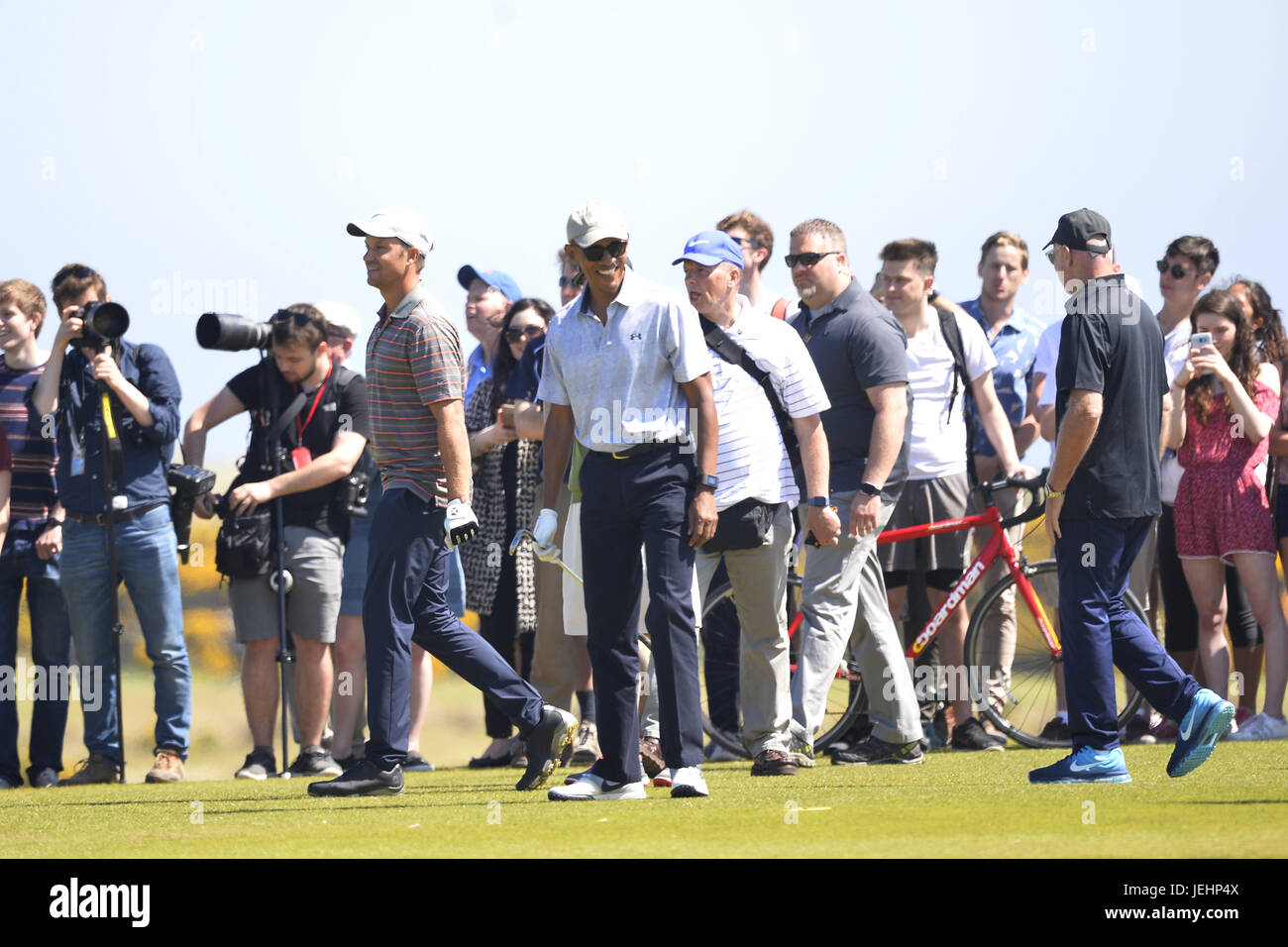 Former US president Barack Obama (light blue shirt) playing a round of ...