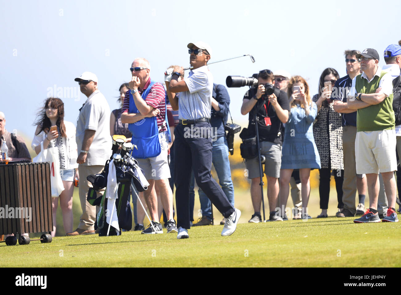 Former US president Barack Obama (light blue shirt) playing a round of ...