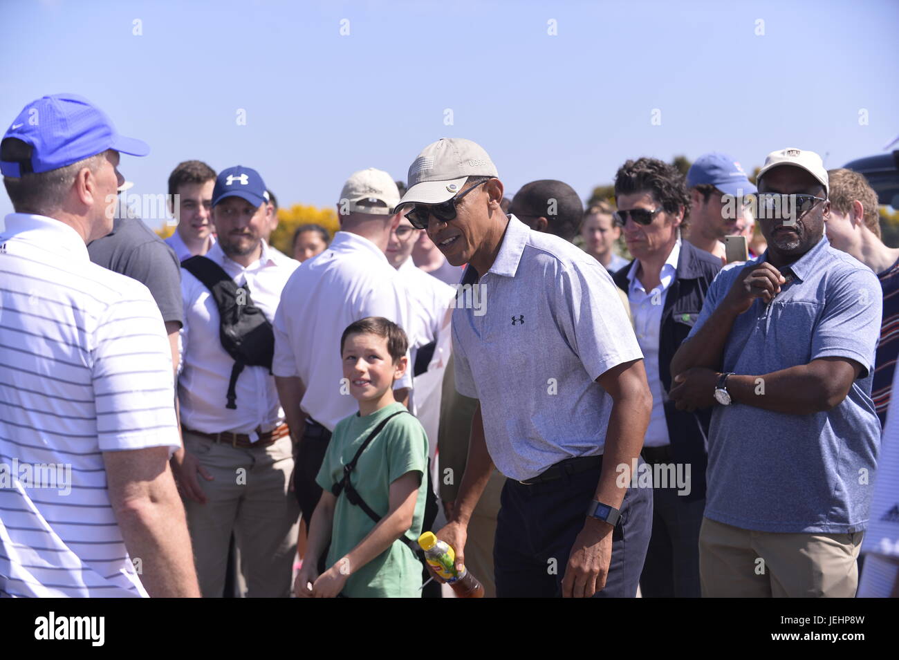 Former US president Barack Obama (light blue shirt) playing a round of ...
