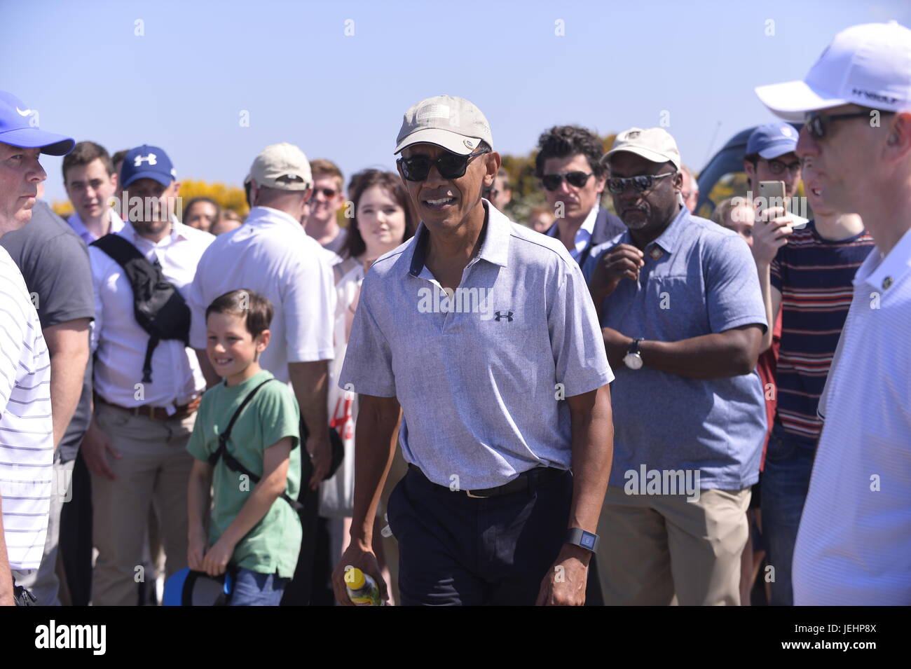 Former US president Barack Obama (light blue shirt) playing a round of ...
