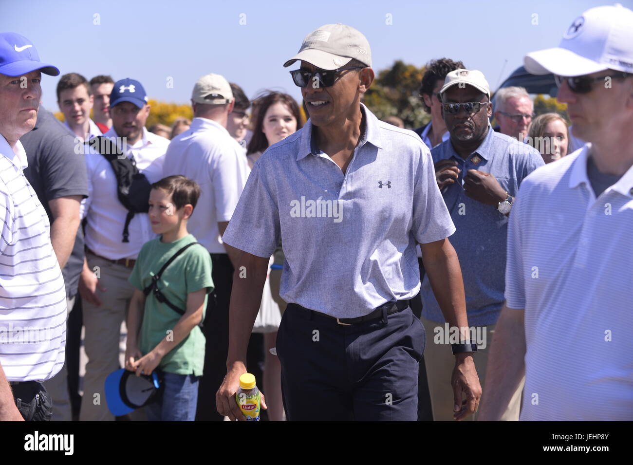Former US president Barack Obama (light blue shirt) playing a round of ...