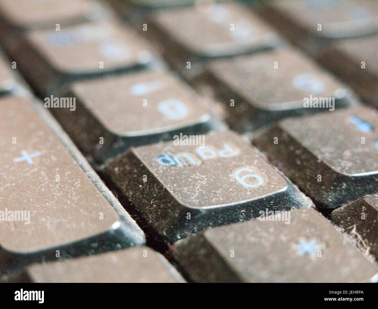 the dirty and dusty keypad macro close up of a black and blue keyboard ...