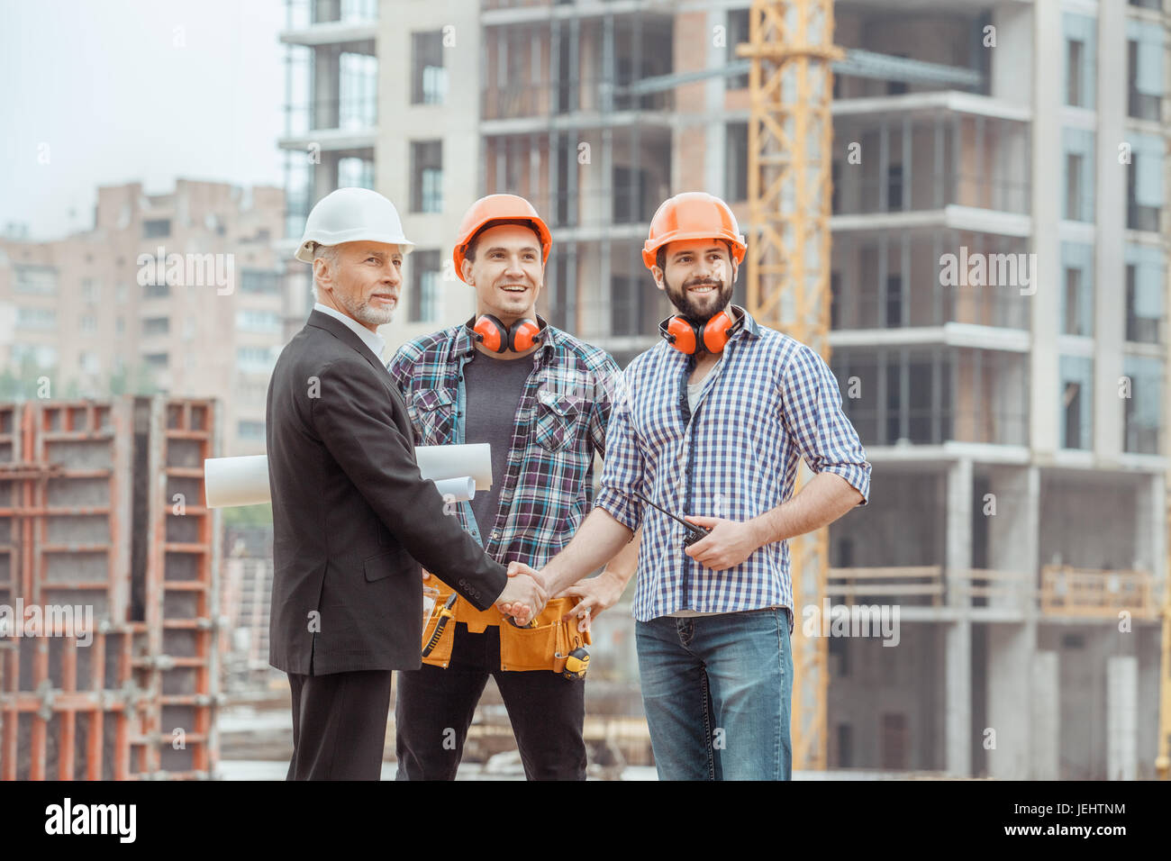Male work building construction engineering occupation shaking hands ...
