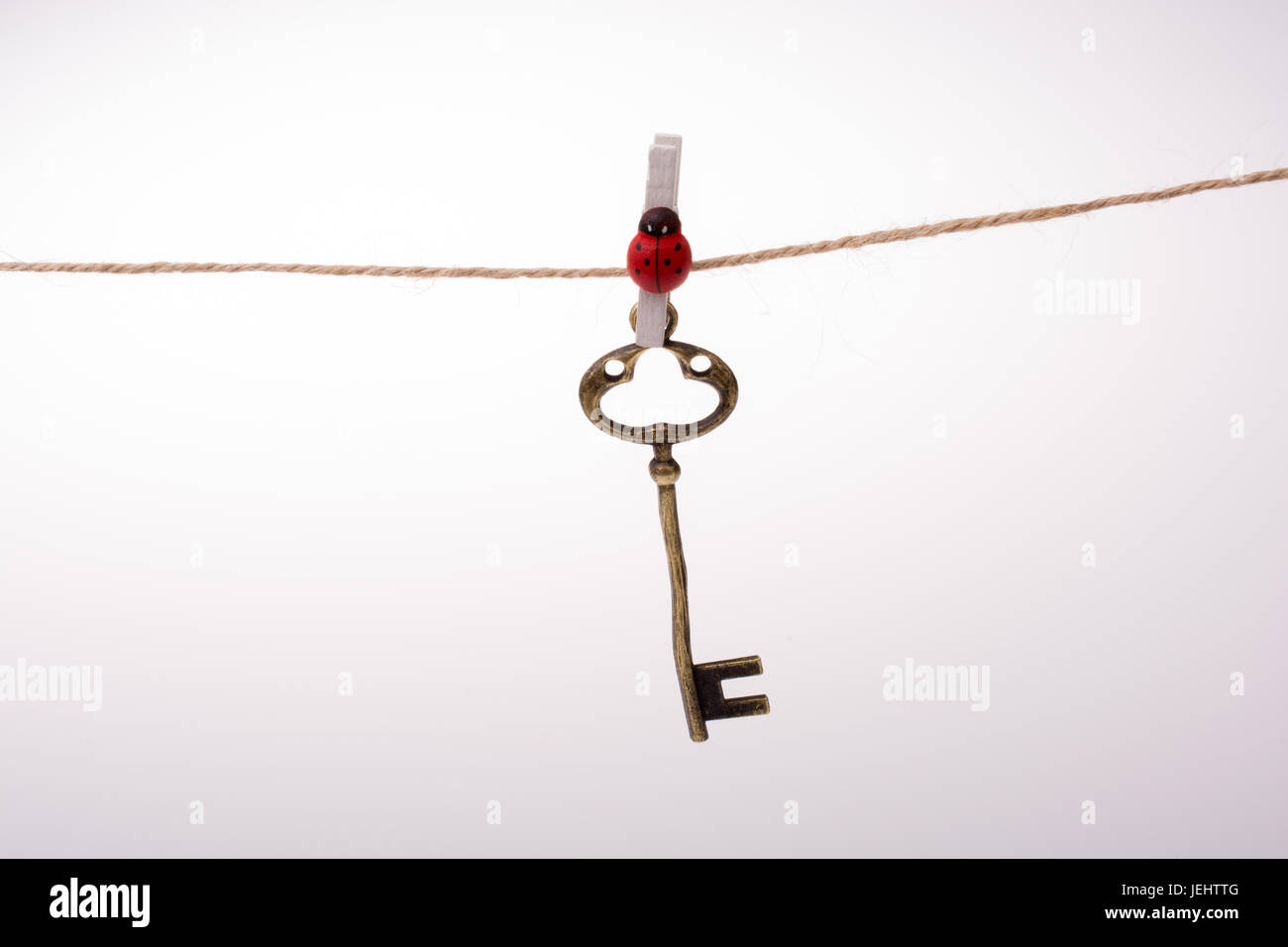 Retro styled golden color key attached to a string in view Stock Photo ...