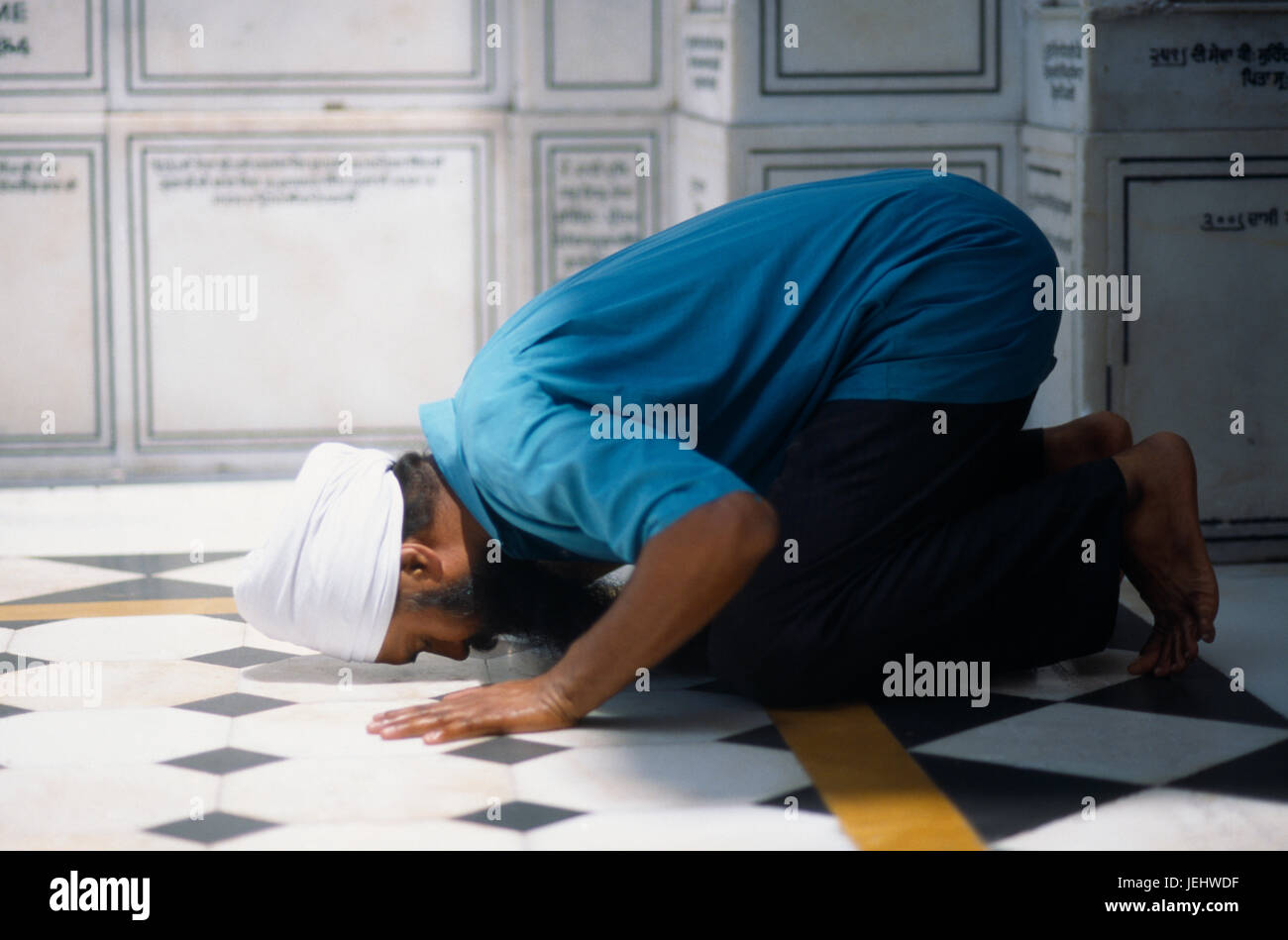 India, Punjab, Amritsar, Sikh man praying inside the Golden Temple ...