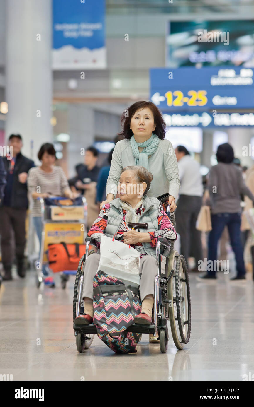SEOUL-OCT. 24, 2015. Woman with disabled mother in a wheelchair on ...