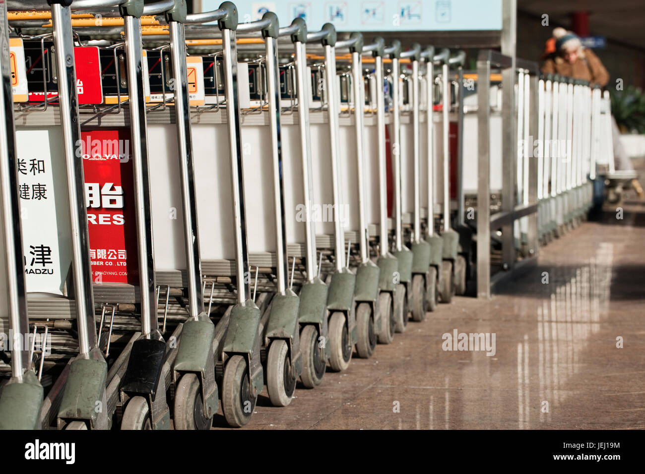BEIJING – DEC. 9, 2011. Lined up baggage trolleys at Beijing Capital ...