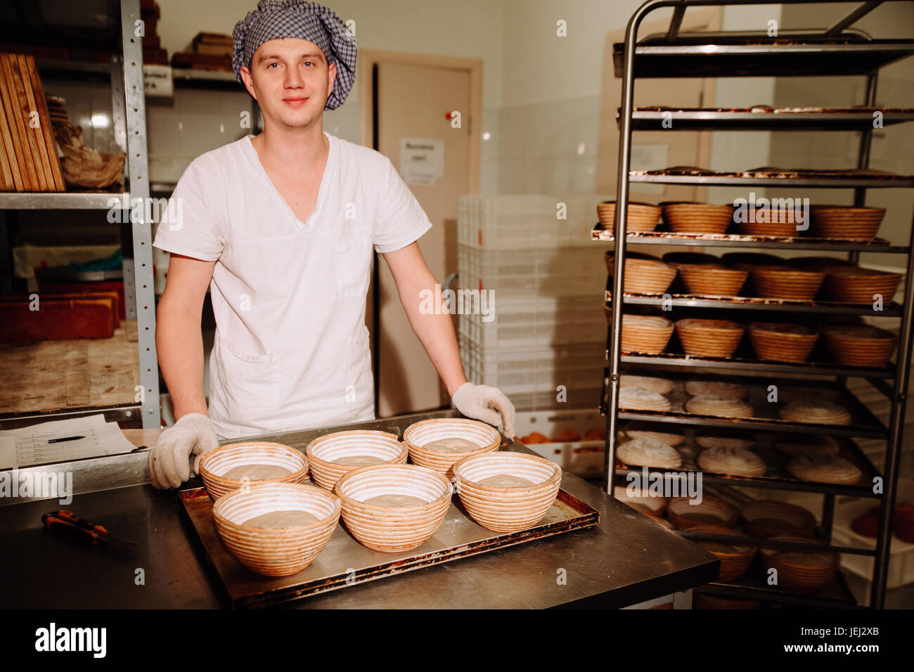 the happy Baker is molding bread looking at camera and smiling Stock ...