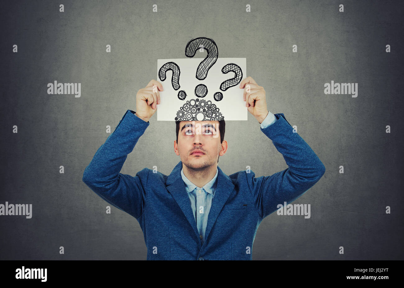 Portrait of confused, thinking young businessman seeks a solution ...