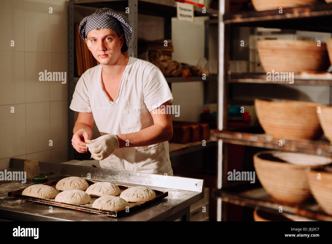 Male baker makes shape dough hi-res stock photography and images - Alamy