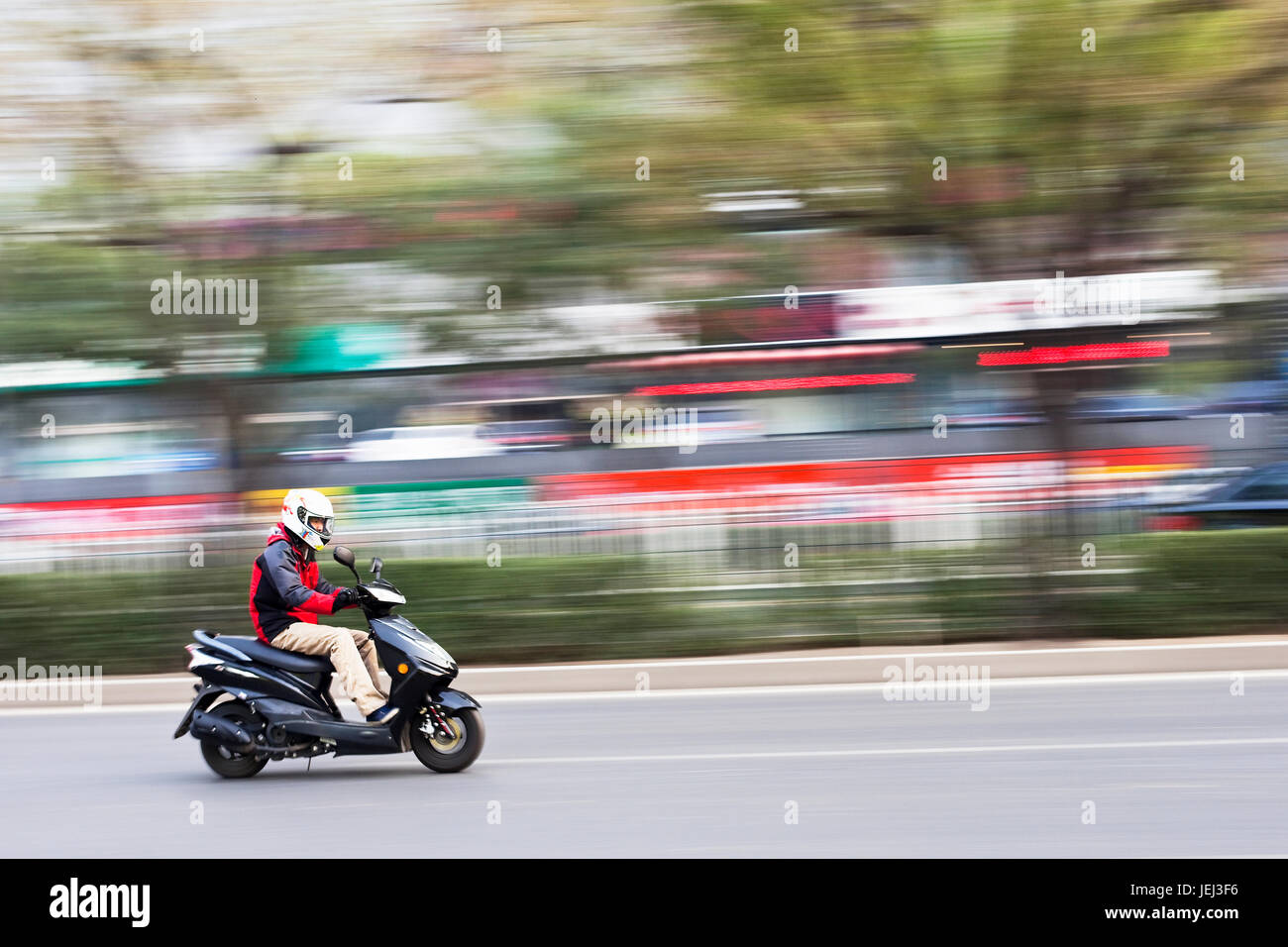 BEIJING – OCT. 28, 2011. Commuter an engine scooter. Engine scooters ...