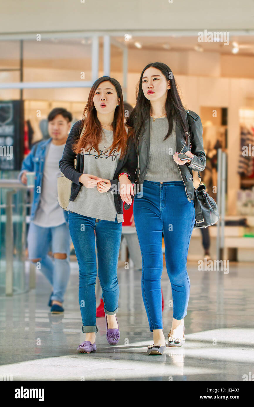 BEIJING-MAY 15, 2016. Fashionable girls in shopping mall. International ...
