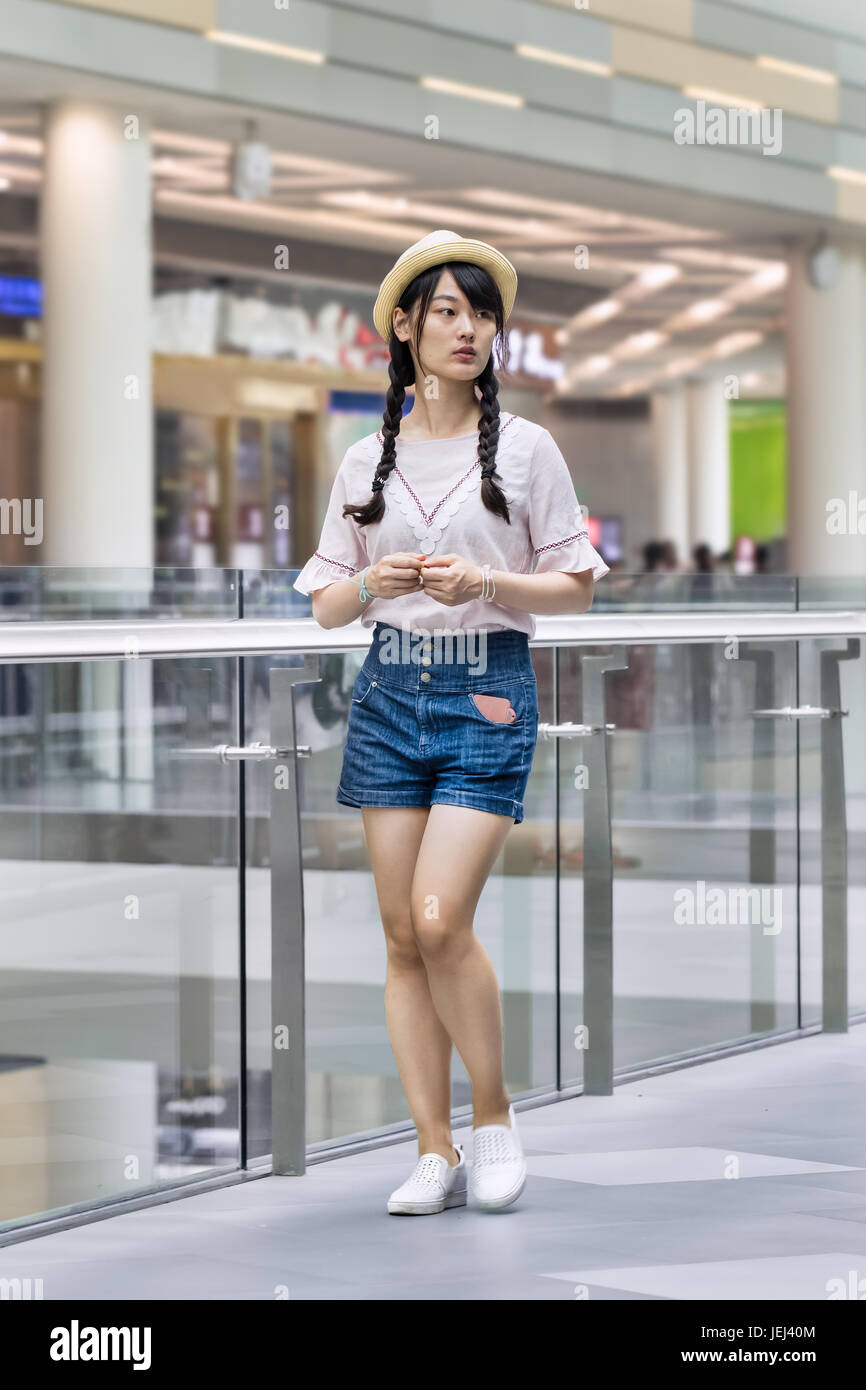 BEIJING-AUGUST 4, 2106. Fashionable young girl in shopping mall ...