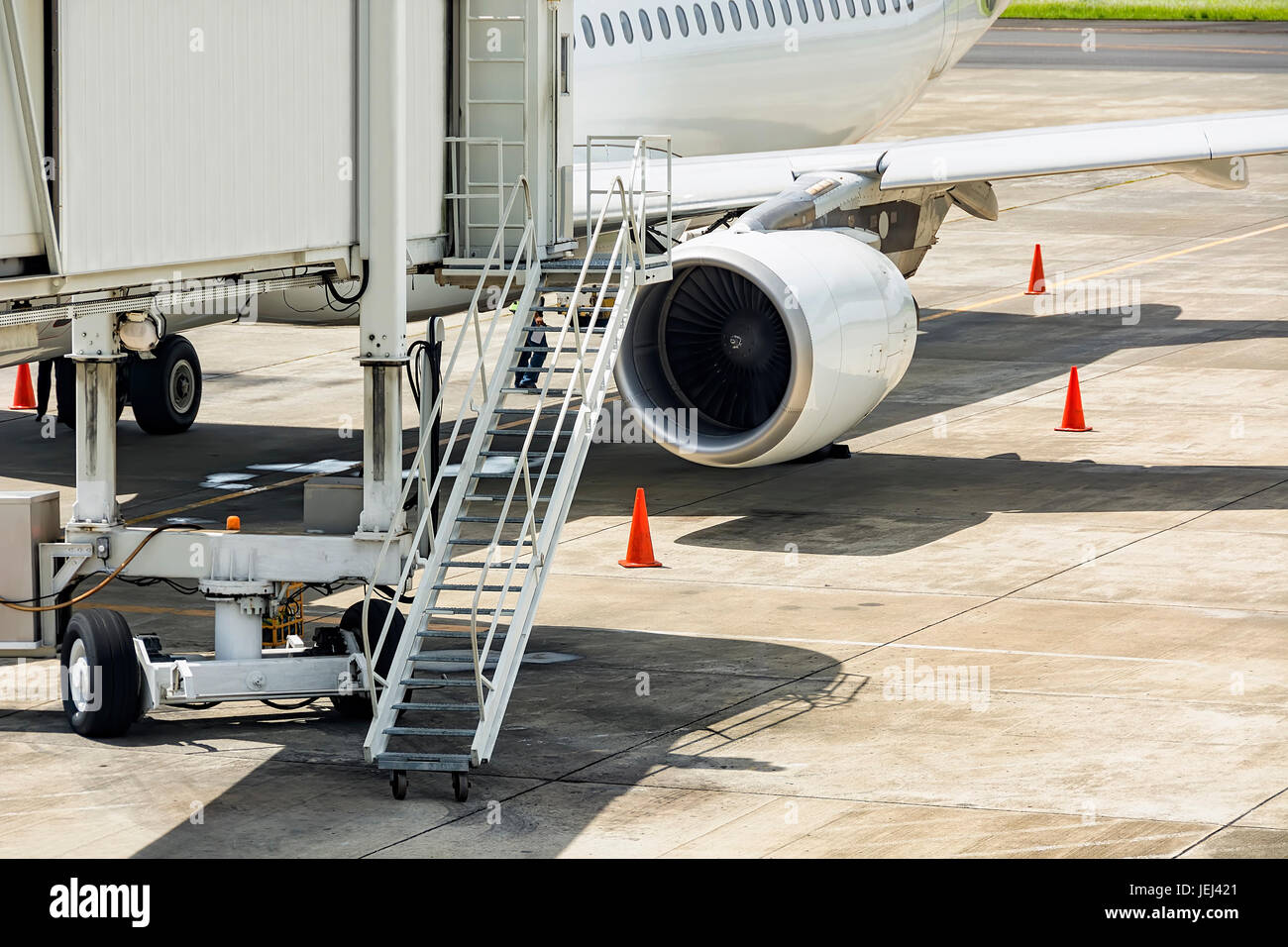 Airport service vehicles standby on airport tarmac with airplane Stock ...