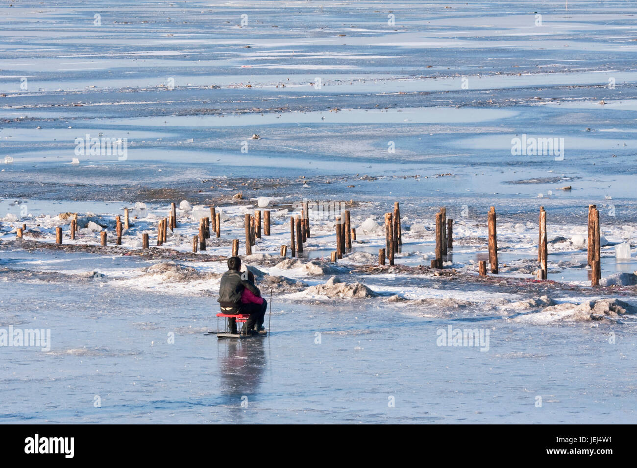 HARBIN-MARCH 7. Father and child on a seat slide at the frozen Songhua ...