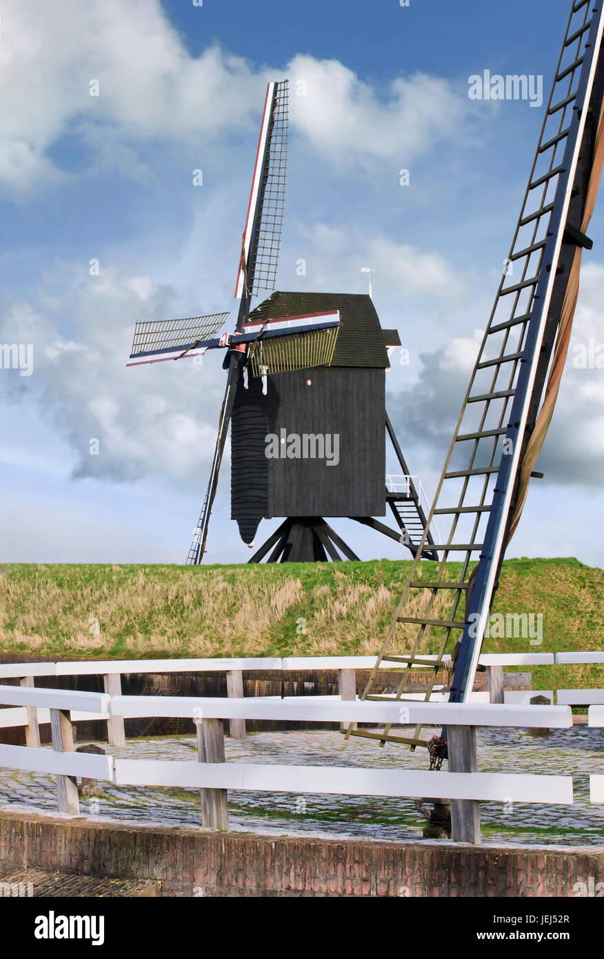 Ancient wooden windmill on a green dyke, Heusen, The Netherlands Stock ...